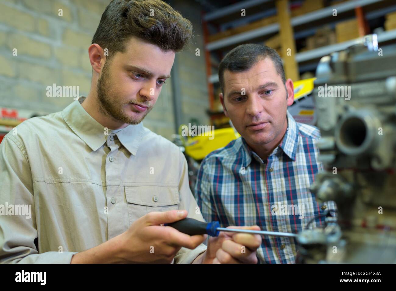 a mechanic apprentice disassembling motor Stock Photo - Alamy