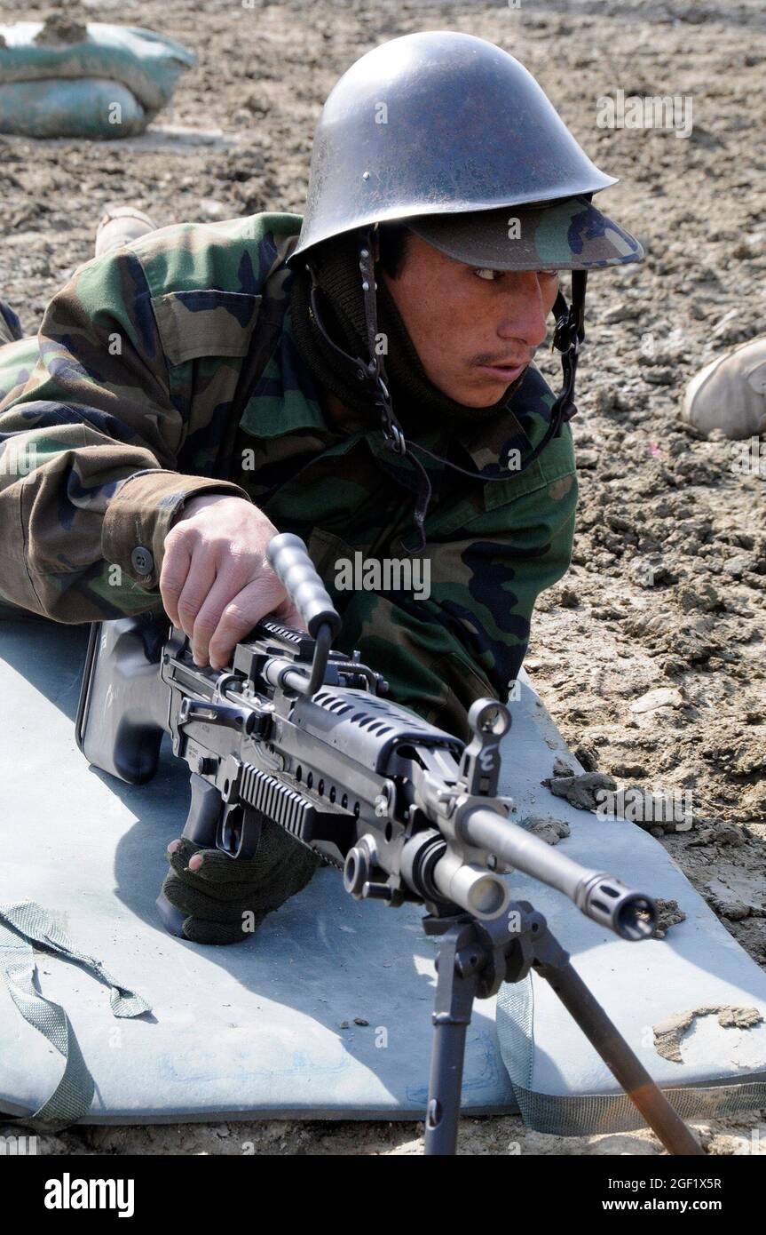 An Afghan National Army trainee demonstrates his knowledge with the M ...