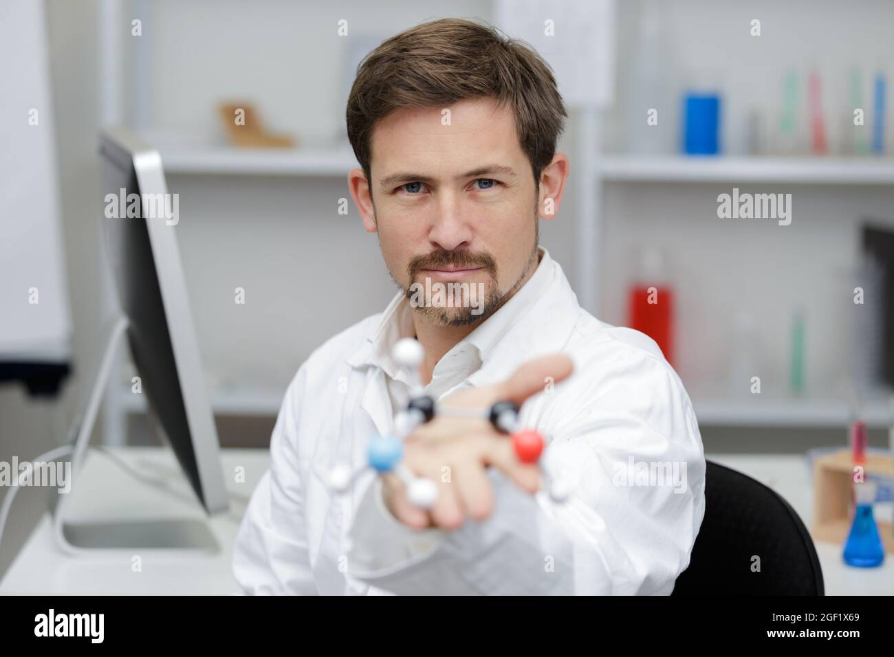 confident male scientist showing dna model Stock Photo - Alamy