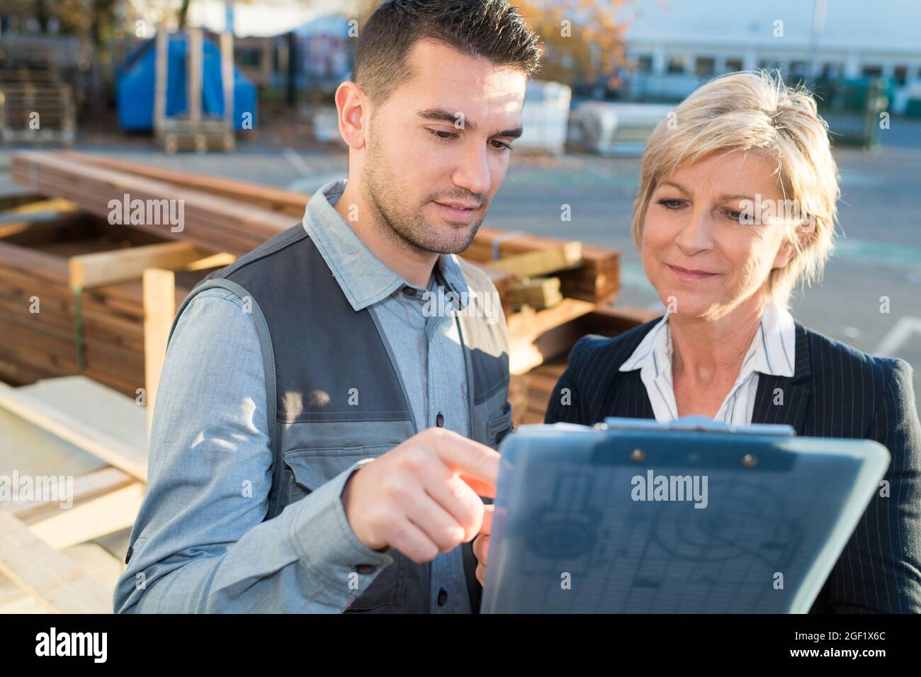 male employee signing a contract with female manager with clipboard ...