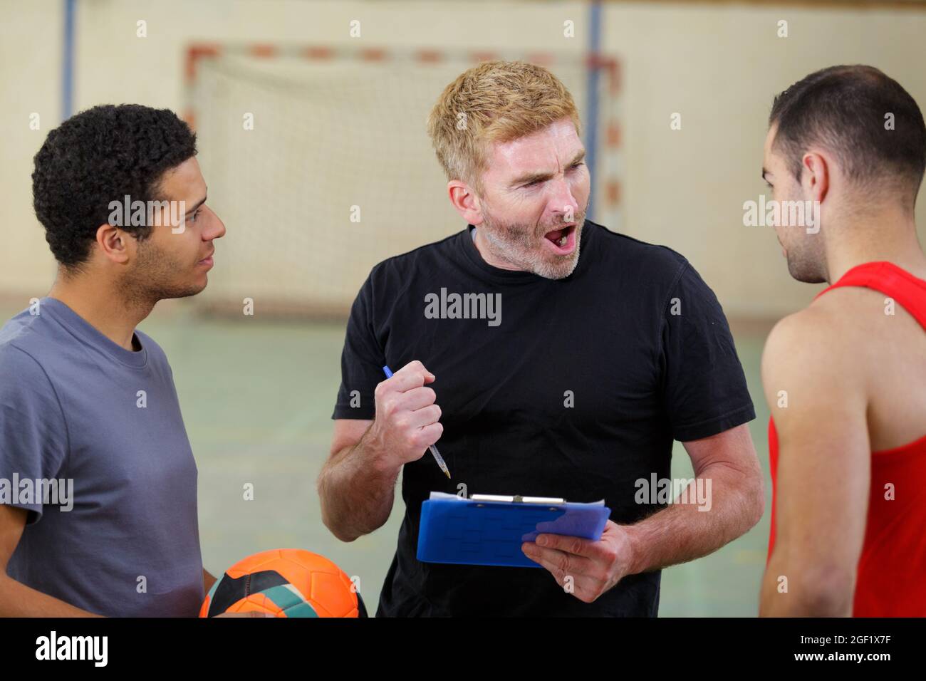 football soccer trainer with workout plan with his team Stock Photo - Alamy