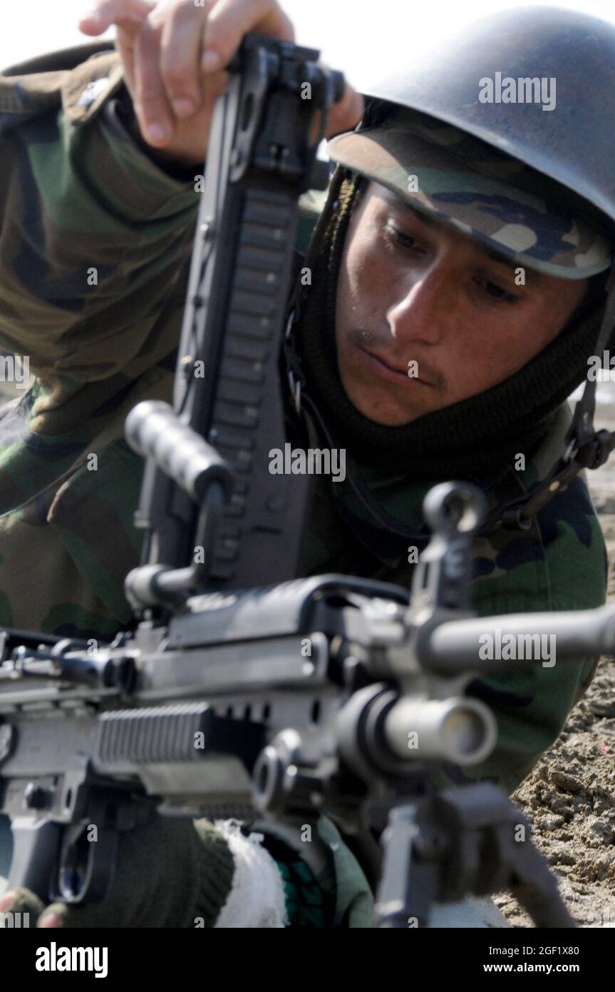 An Afghan National Army trainee demonstrates his knowledge with the M ...