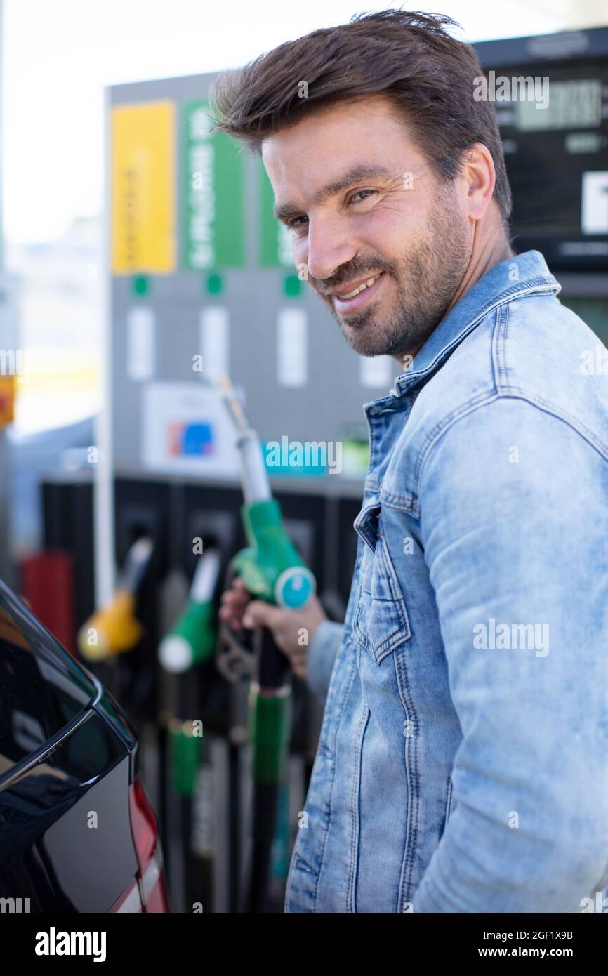 man pumping gasoline fuel in car at gas station Stock Photo - Alamy