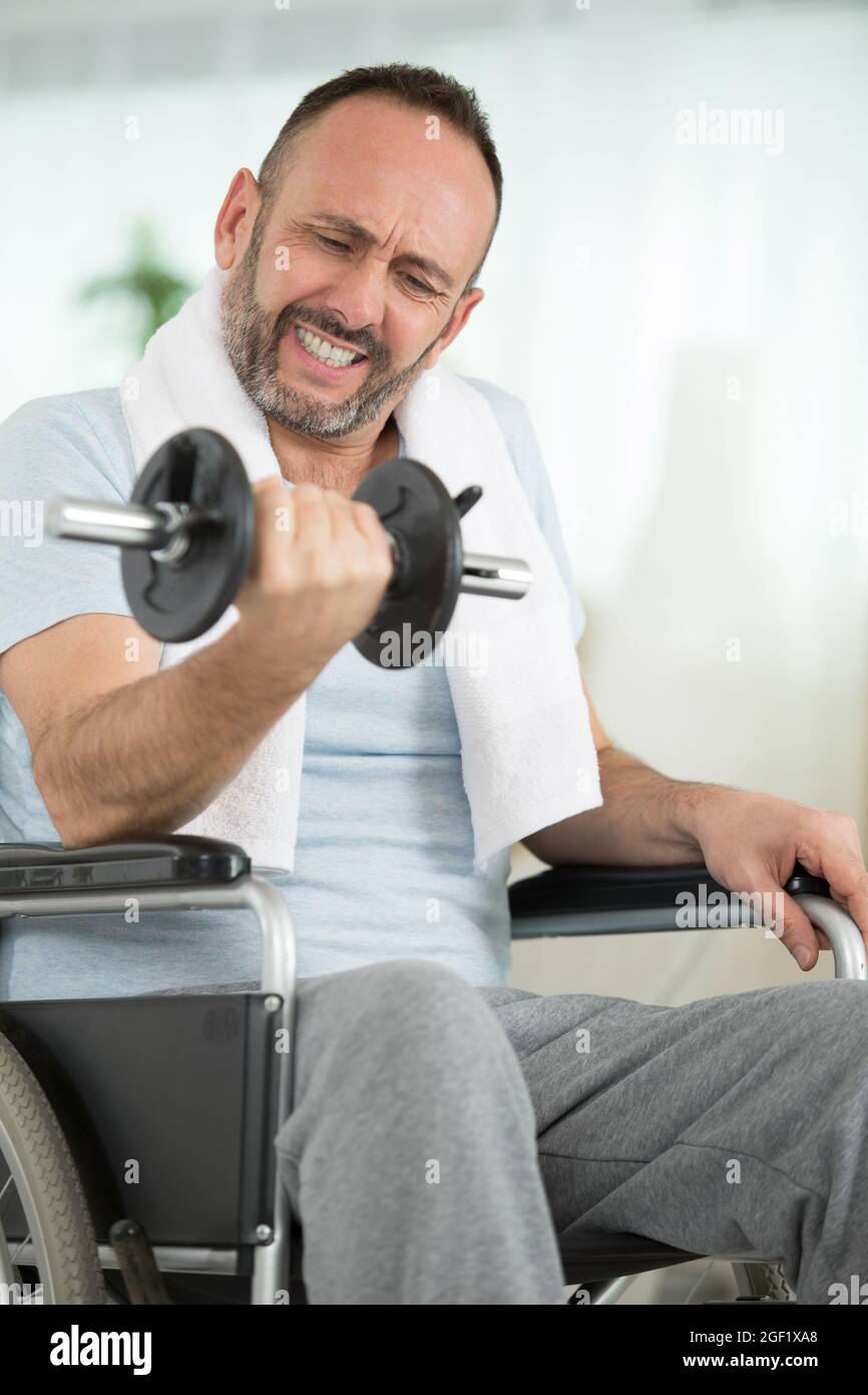 handicapped man on wheelchair working out Stock Photo - Alamy