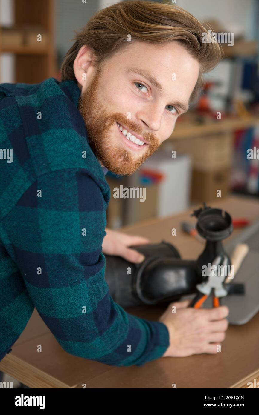 man using pliers on mechanical component Stock Photo - Alamy