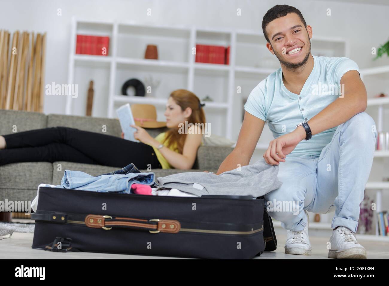 happy man packing for his holiday Stock Photo - Alamy