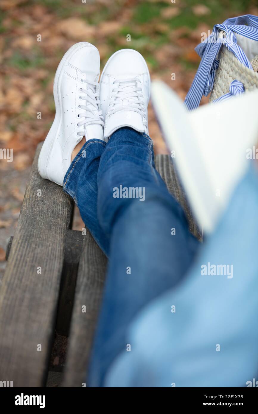 Person sitting on bench in urban garden hi-res stock photography and ...