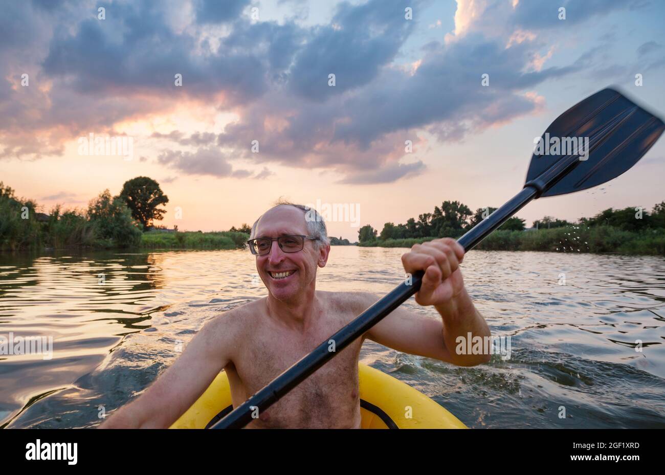 Rear view of kayaker paddle kayak in summer river Stock Photo - Alamy