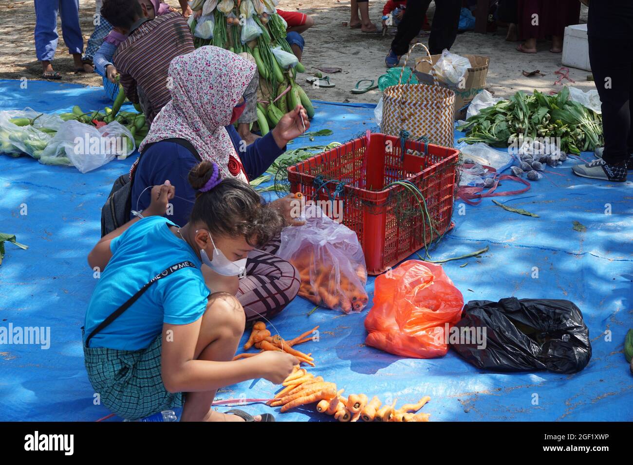 People arrange vegetables to make tumpeng sayur (vegetable cone) for ...