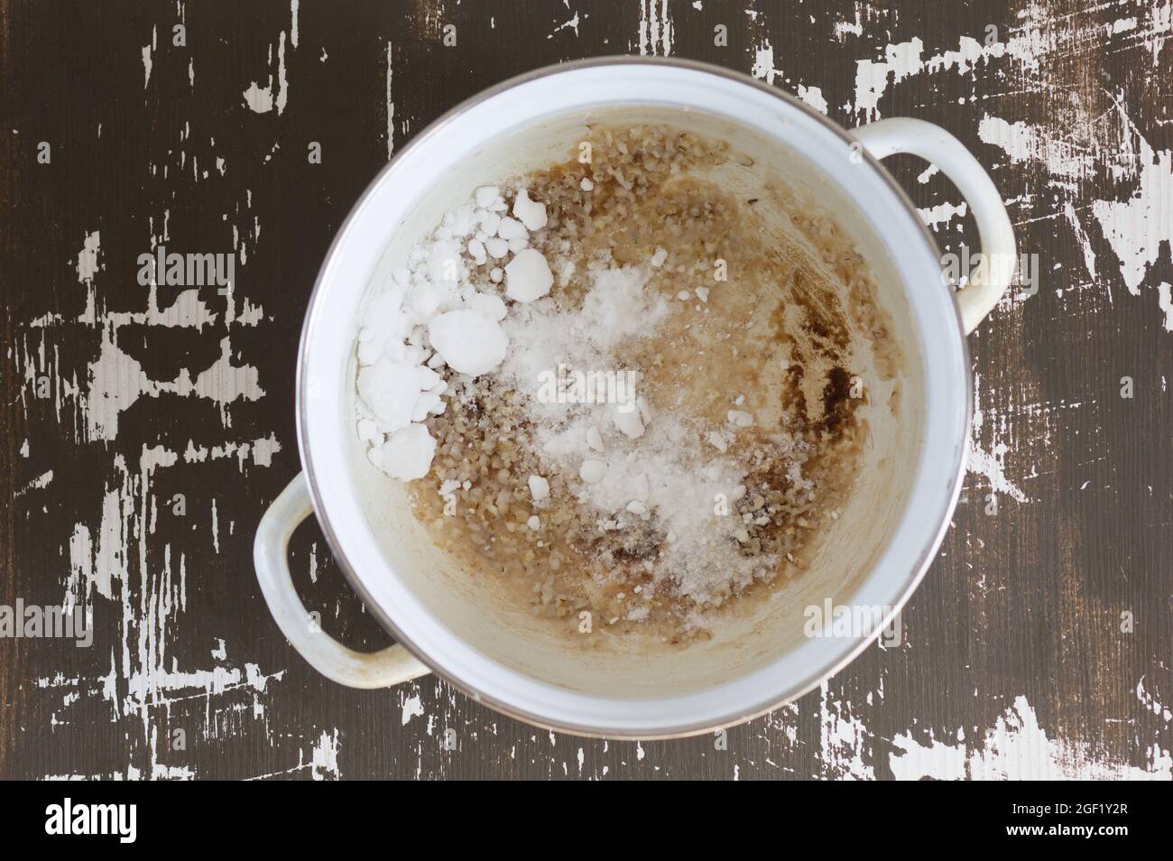 Top view of pan with burnt bottom after cooking porridge and soda in it ...