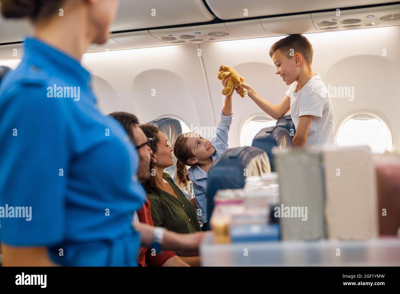 Two happy kids playing with a toy during flight. Family traveling ...
