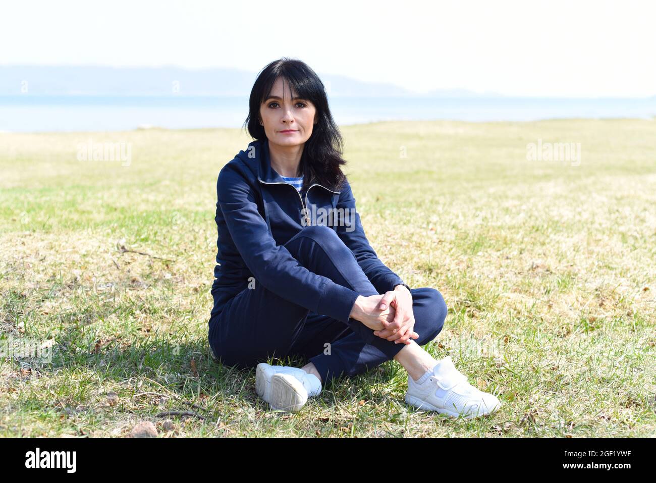 45 y.o. Russian woman sitting and enjoying nature at the beach of ...