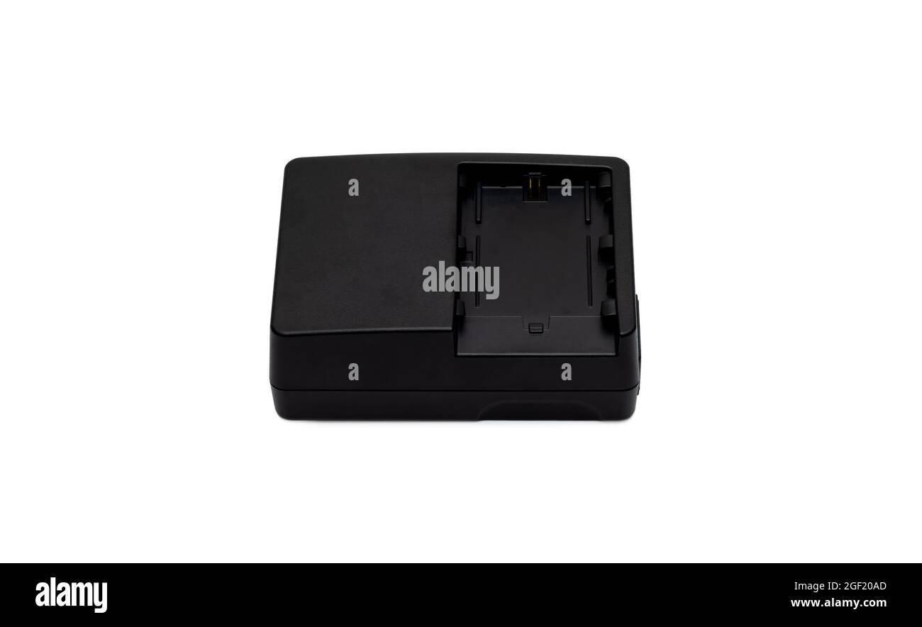 Old used black camera charging adapter on isolated white background ...
