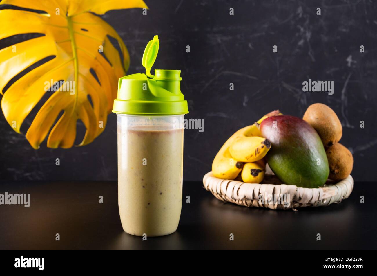 Fresh protein drink in a shaker. Protein drink with banana and fruit ...