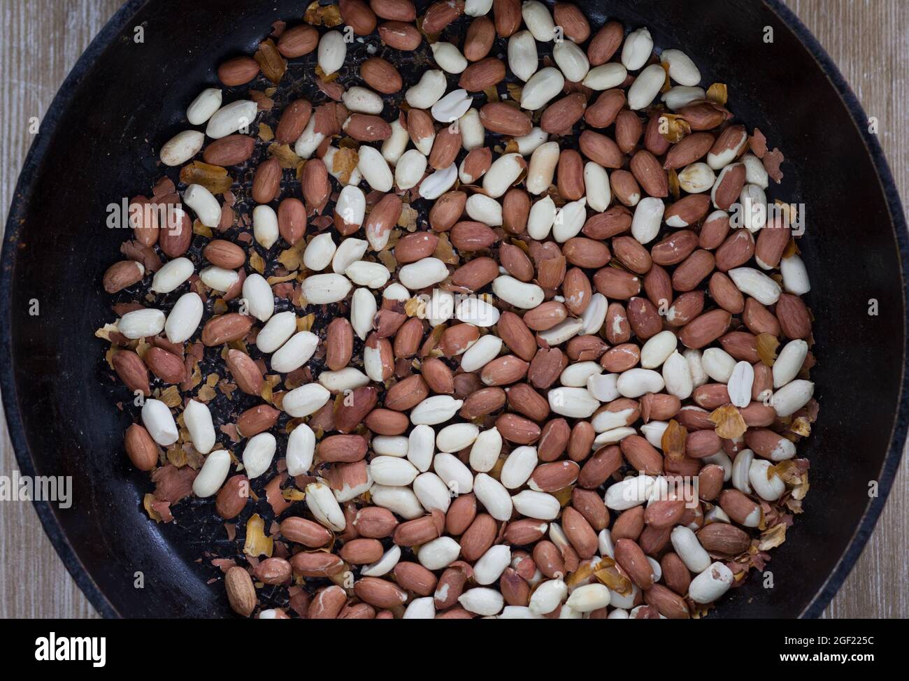 Top view of peanut with seed coat frying on pan Stock Photo - Alamy