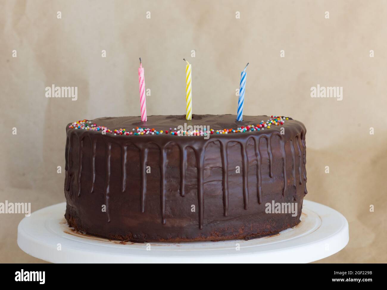 Chocolate cake with three candles without lights Stock Photo - Alamy