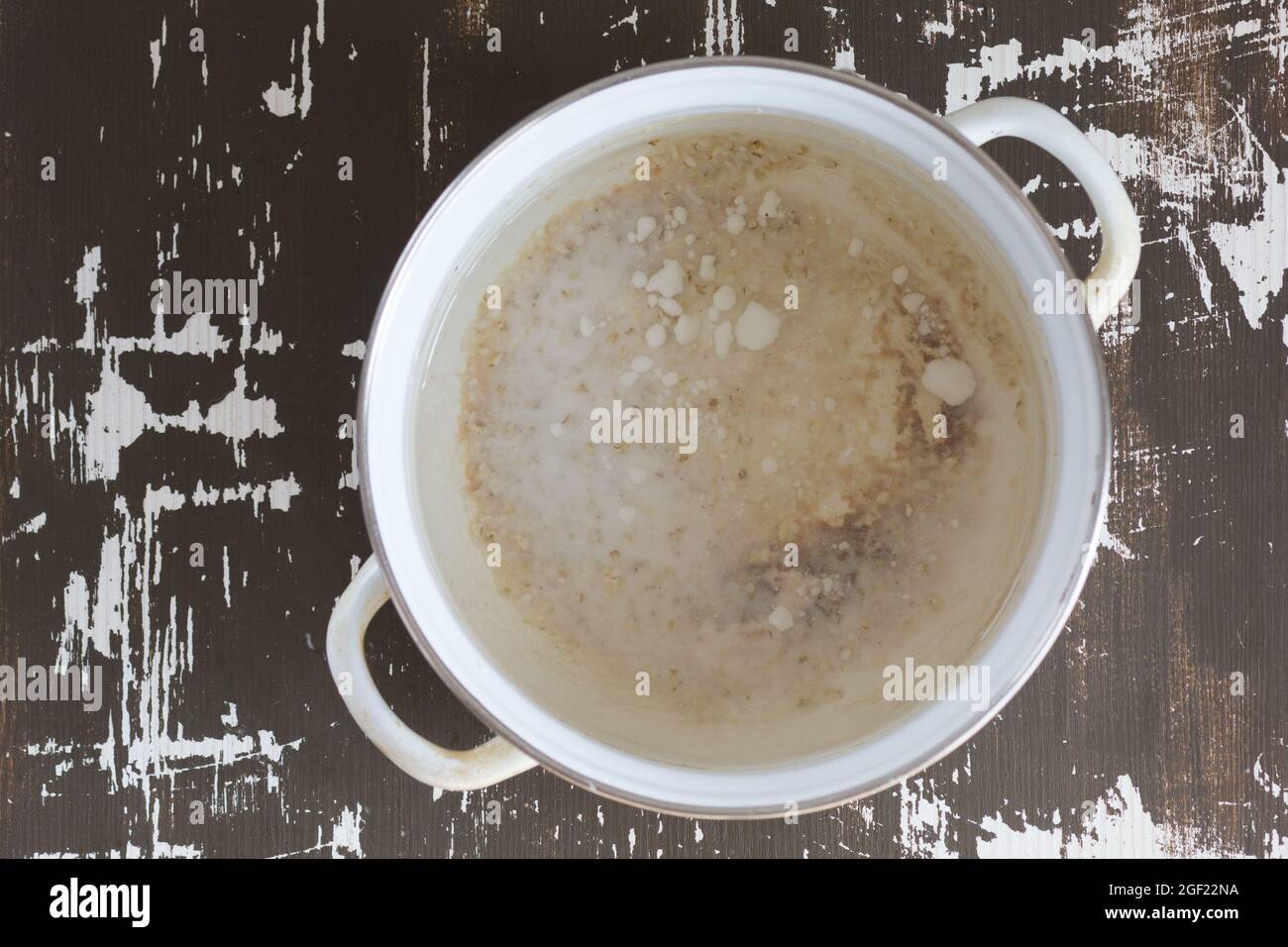 Top view of pan with burnt bottom after cooking porridge and soda with ...