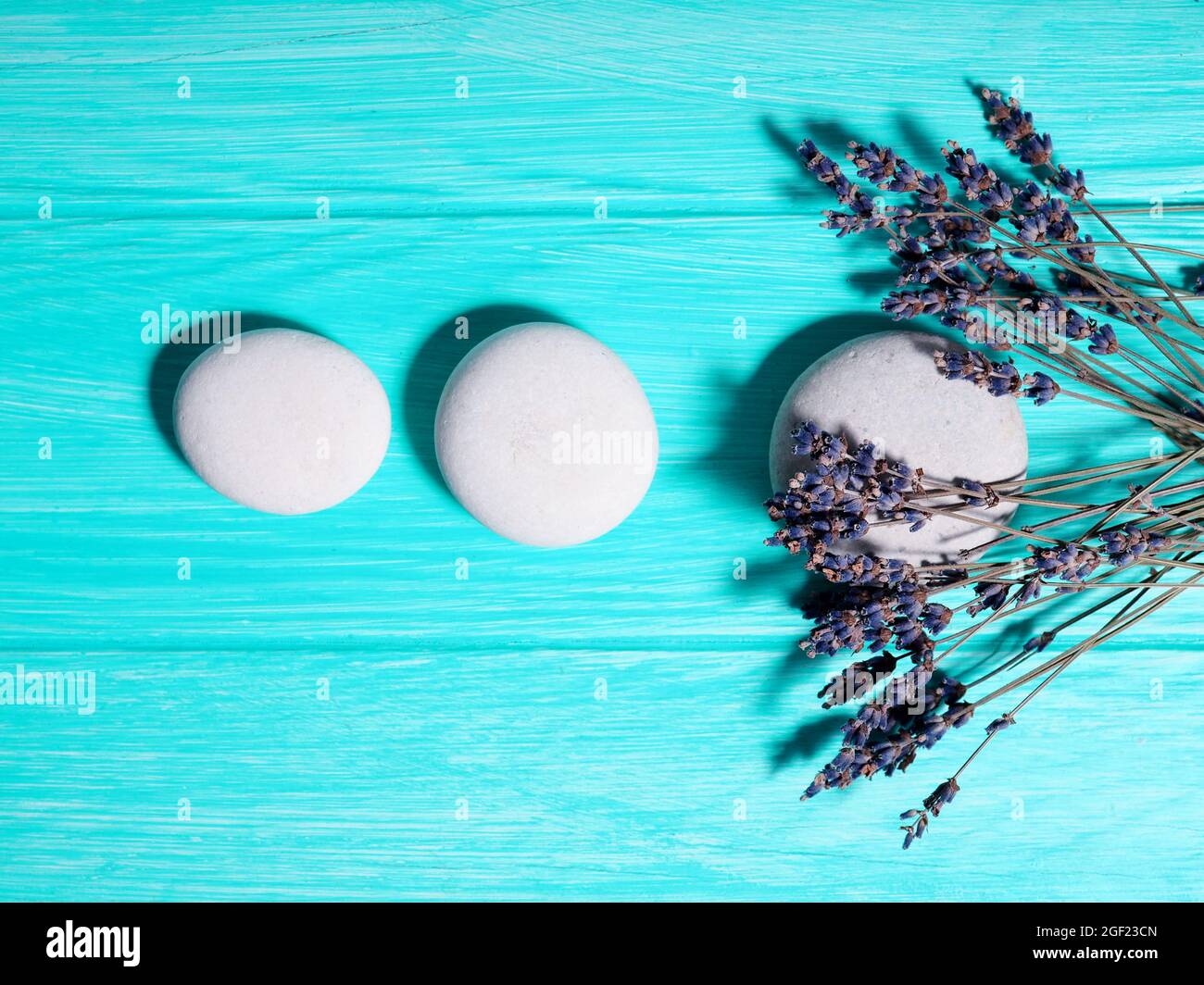 Three white zen stones in a row in a line on a blue background Stock ...