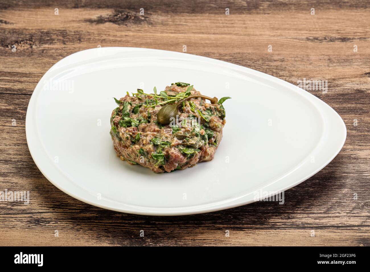 Raw beef tartar snack with capers Stock Photo - Alamy