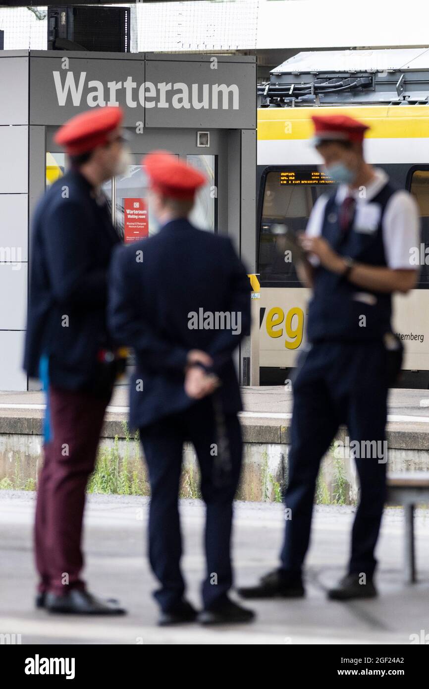 Stuttgart, Germany. 23rd Aug, 2021. Deutsche Bahn employees stand on an ...