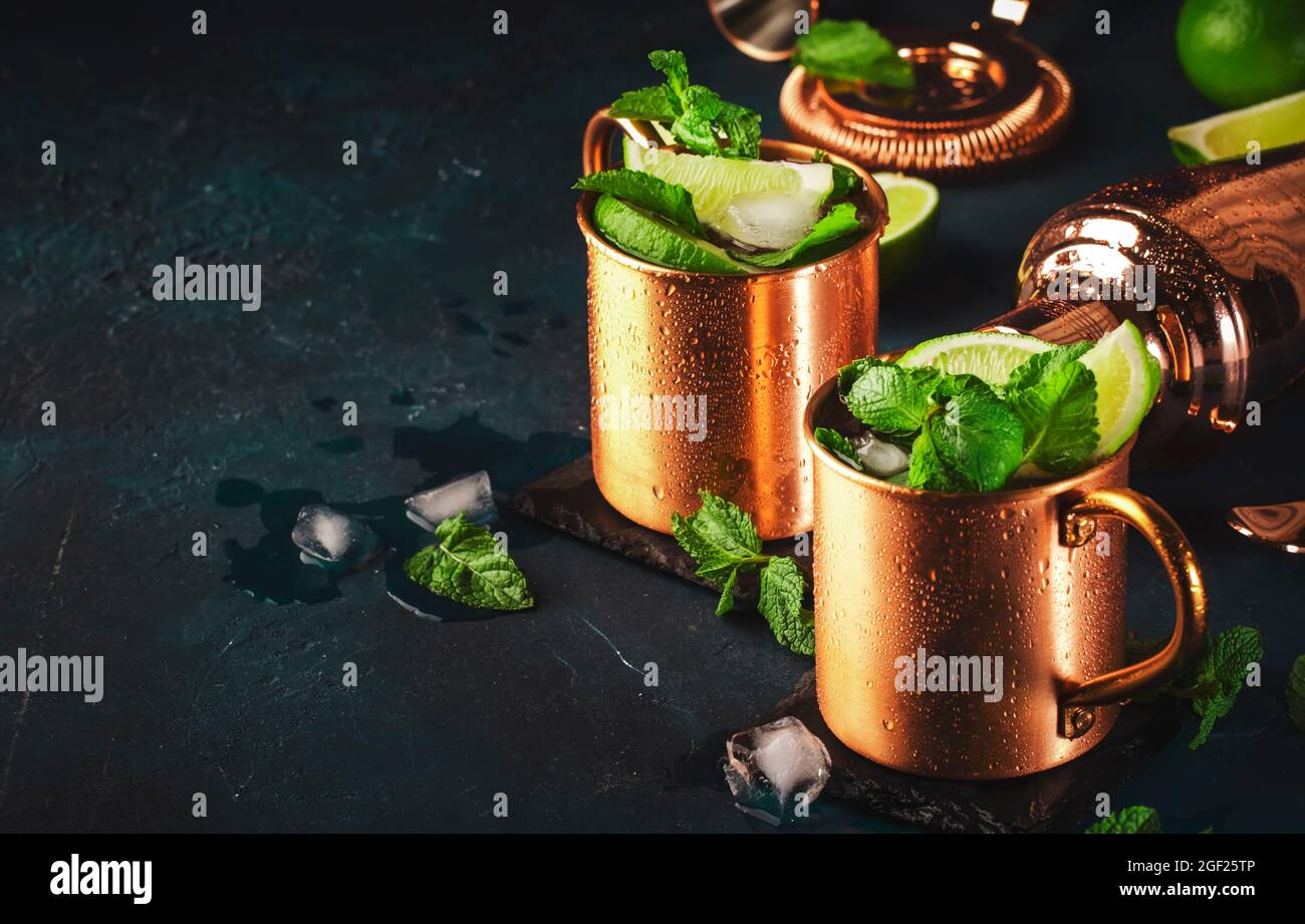 Moscow mule cocktail in copper mug with lime, ice, ginger beer, vodka ...