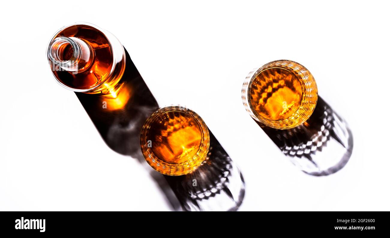 American bourbon whiskey in glasses and bottle, white background with ...