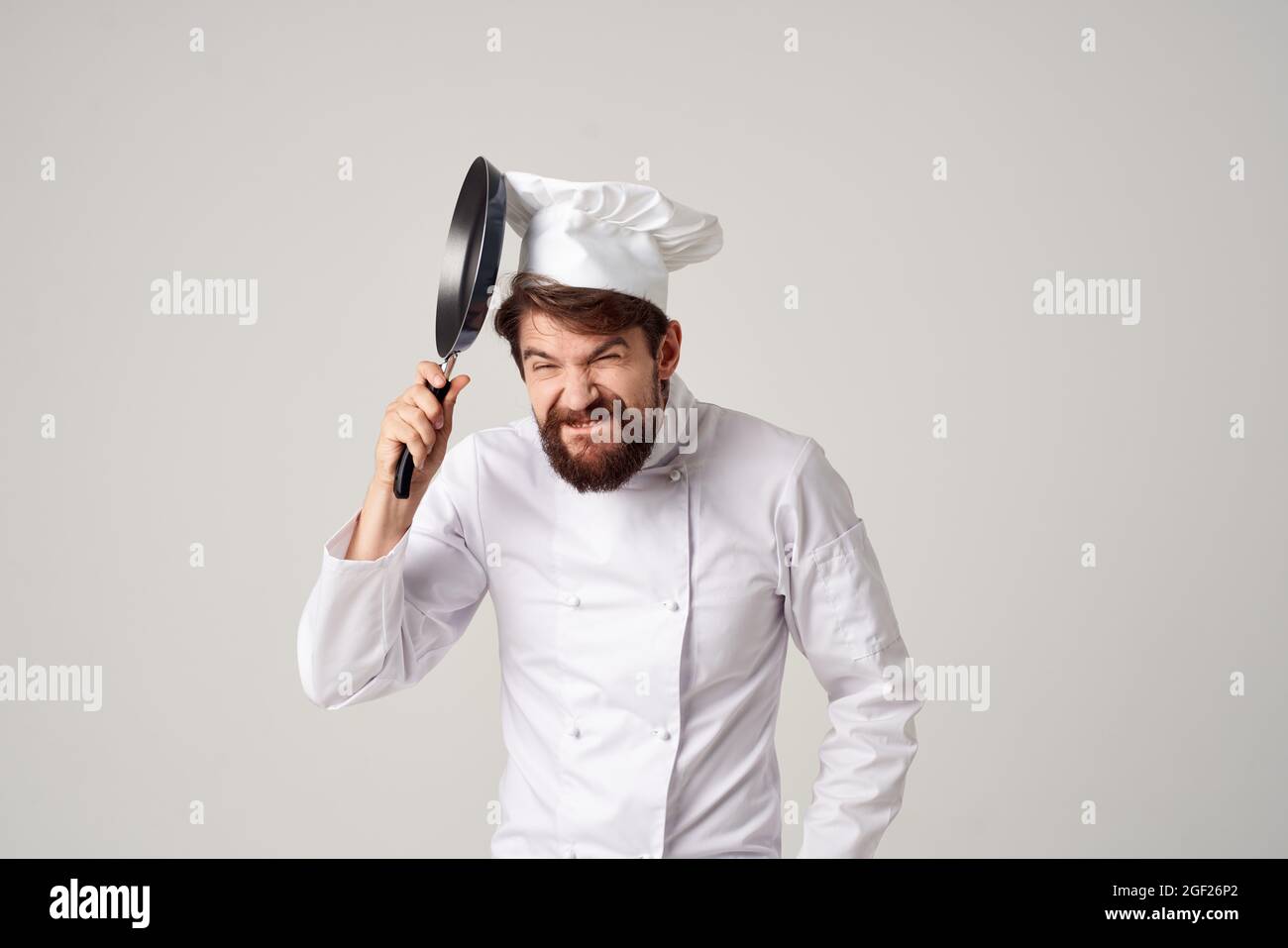 a man in a chef's uniform pan cooking kitchen isolated background Stock ...