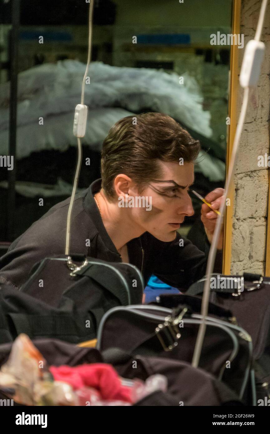 Male ballet dancer applies makeup for his leading role in a production ...