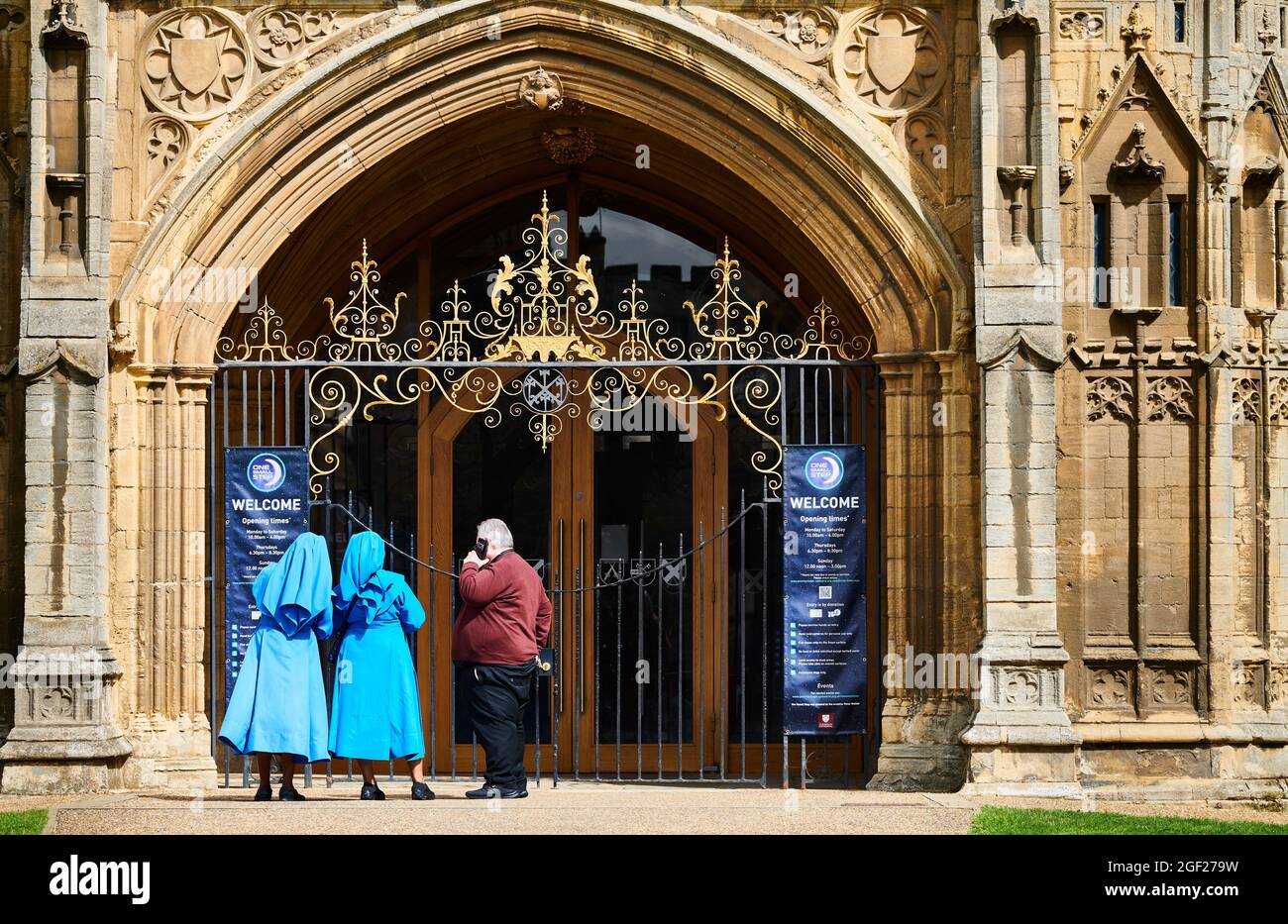An english priest and two african nuns at the entrance of the christian ...