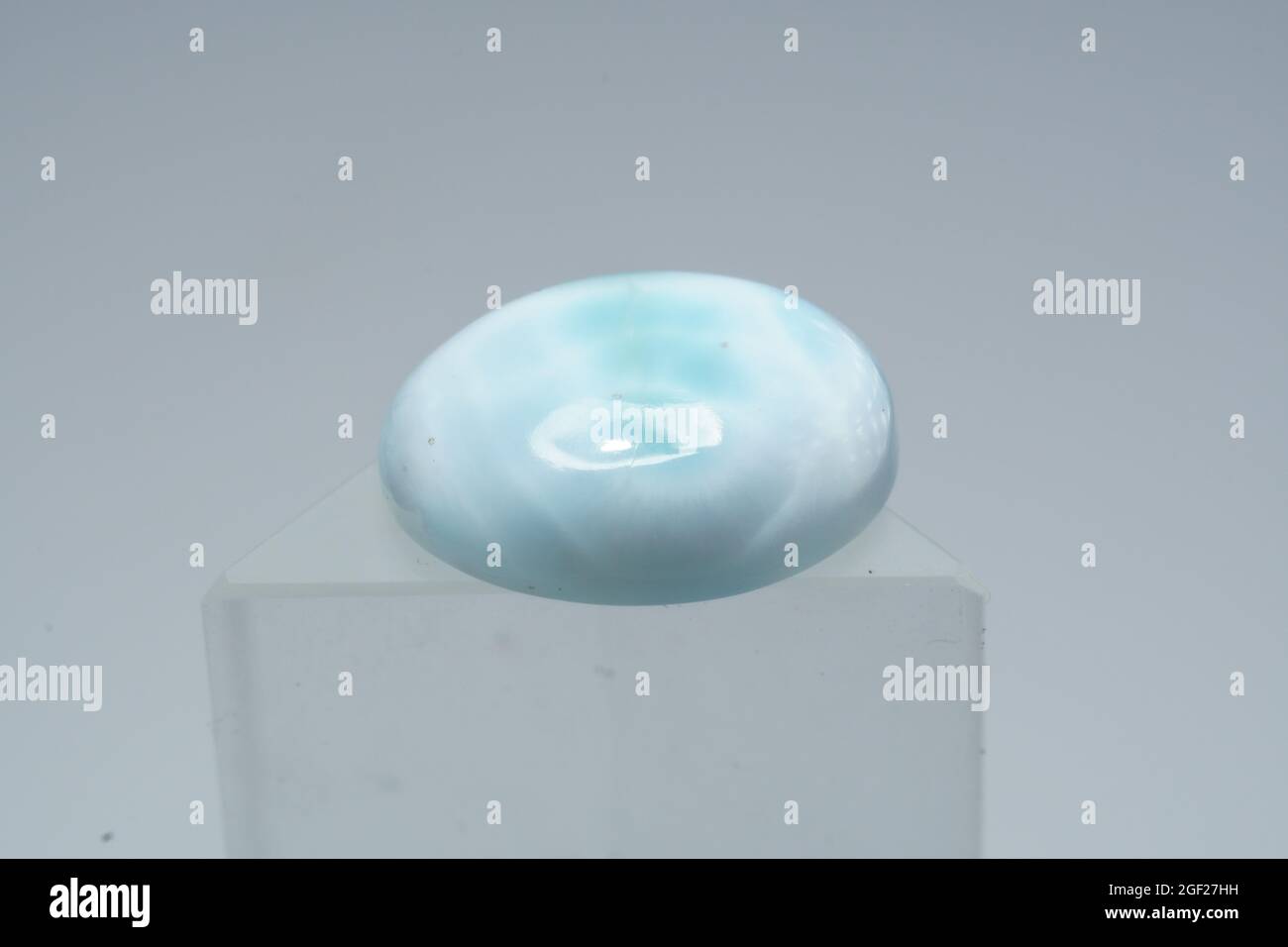 Natural larimar stone on a stand on a white background Stock Photo - Alamy