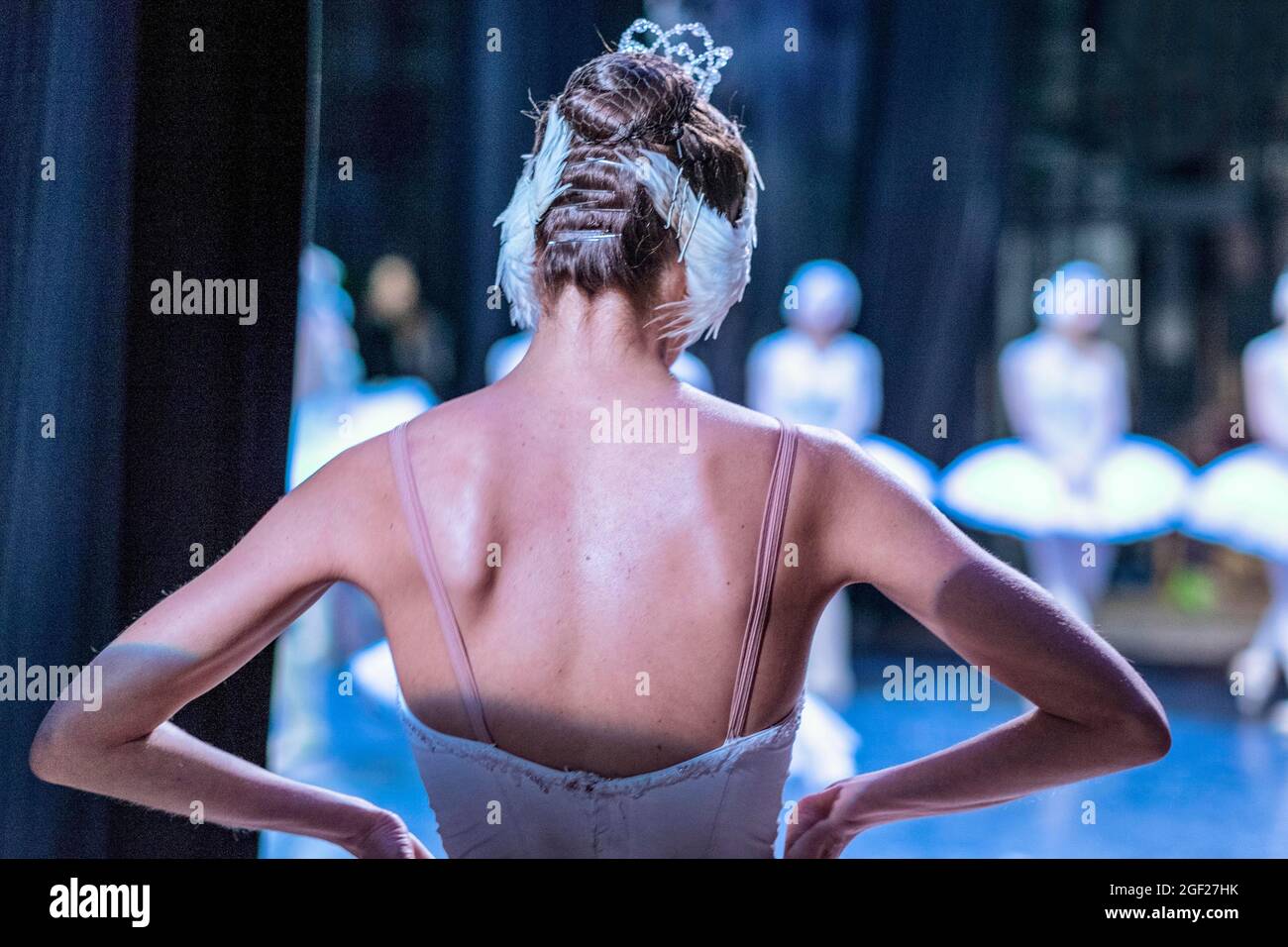 Ballerina waits backstage for the appropriate cue for her entrance in a ...