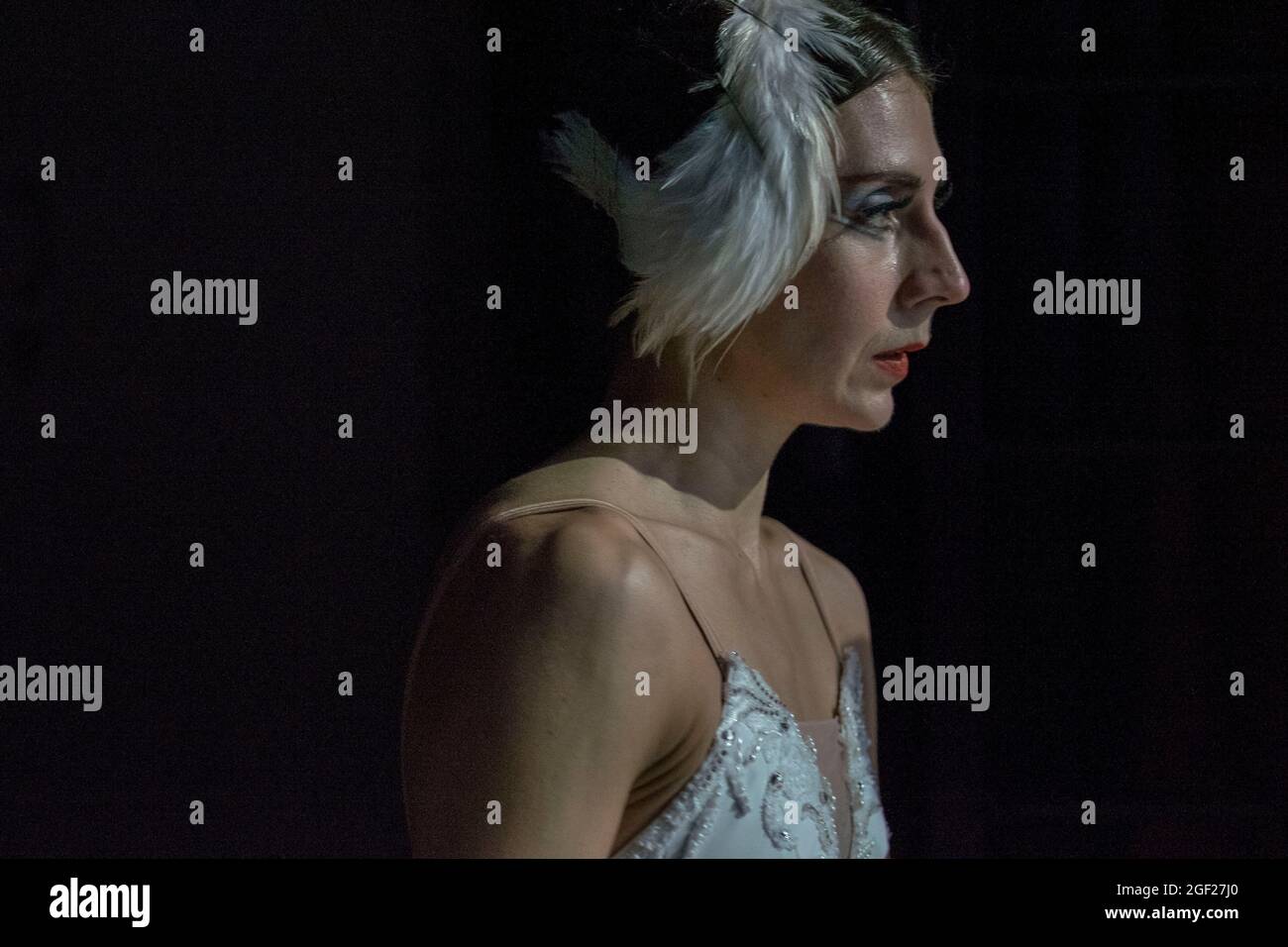 Ballerina waits backstage for the appropriate cue for her entrance in a ...