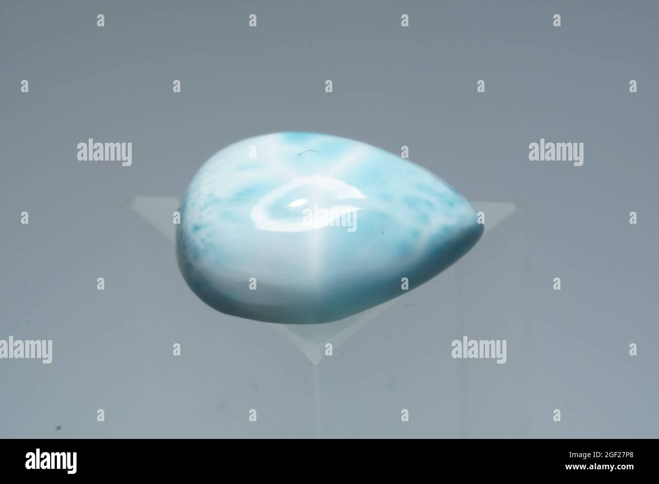 Natural larimar stone on a stand on a white background Stock Photo - Alamy