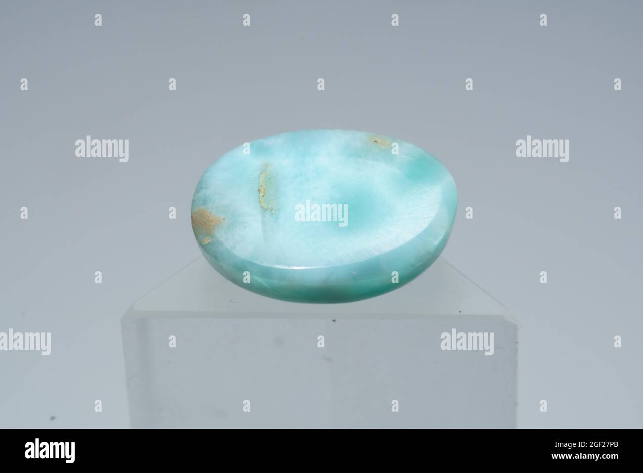 Natural larimar stone on a stand on a white background Stock Photo - Alamy