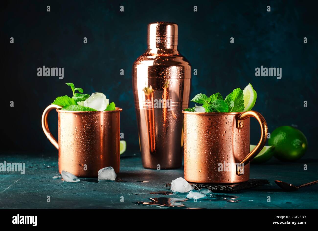 Moscow mule cocktail in copper mug with lime, ice, ginger beer, vodka ...