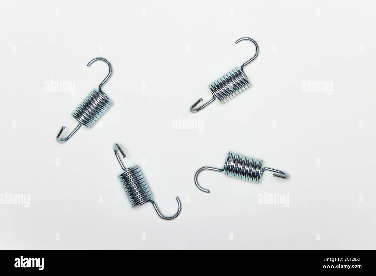 Four metal springs on the table, parts for car repair. A set of spare ...