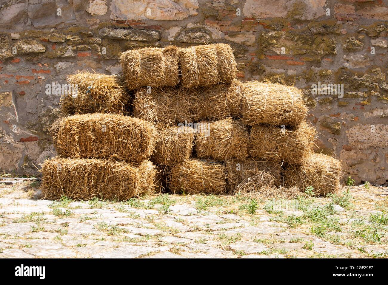 harvested hay for animal feed at the stone wall Stock Photo - Alamy