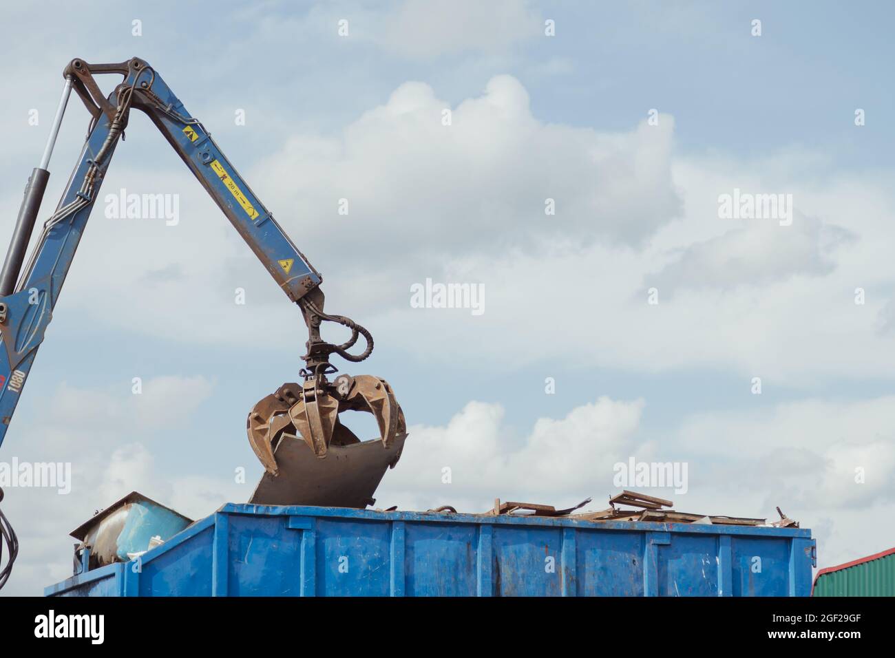 Crane-loading scrap grabber old metal at industrial metal recycling ...