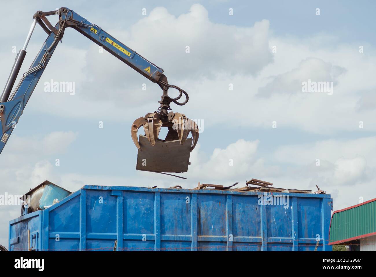 Crane-loading scrap grabber old metal at industrial metal recycling ...