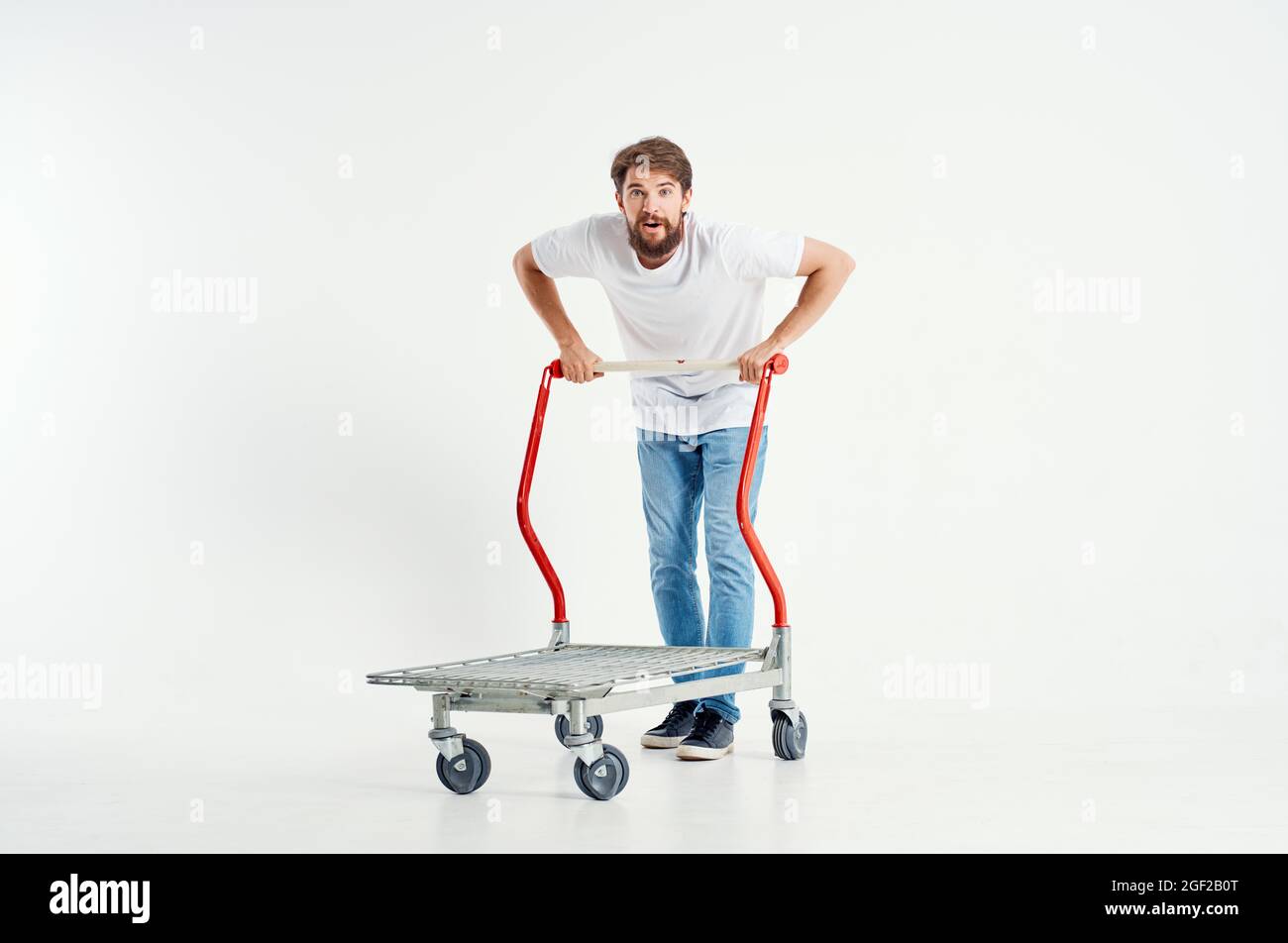 Cheerful man ride a cart entertainment shipping light background Stock ...