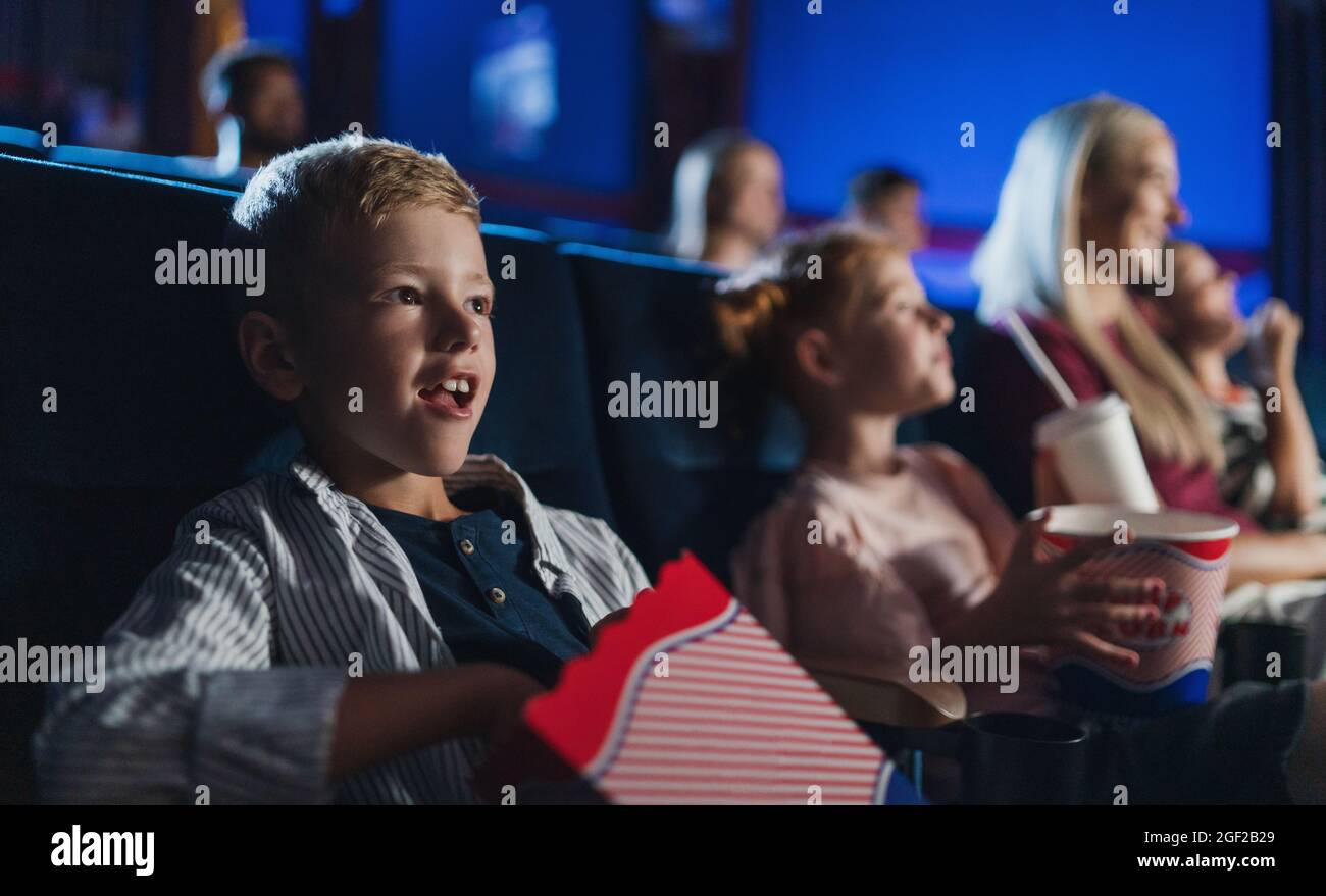 Boy eating popcorn watching movie hi-res stock photography and images ...