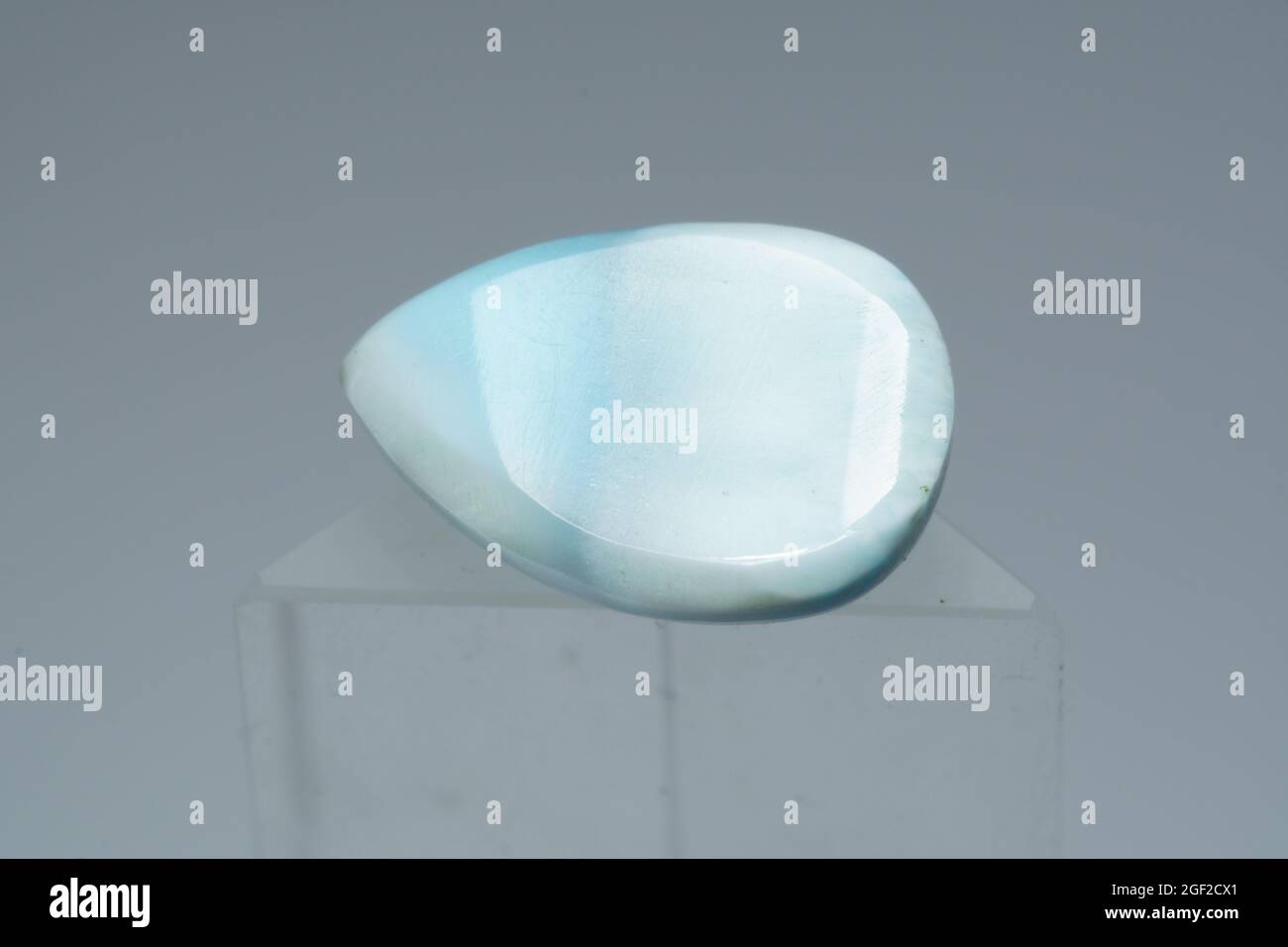 Natural larimar stone on a stand on a white background Stock Photo - Alamy