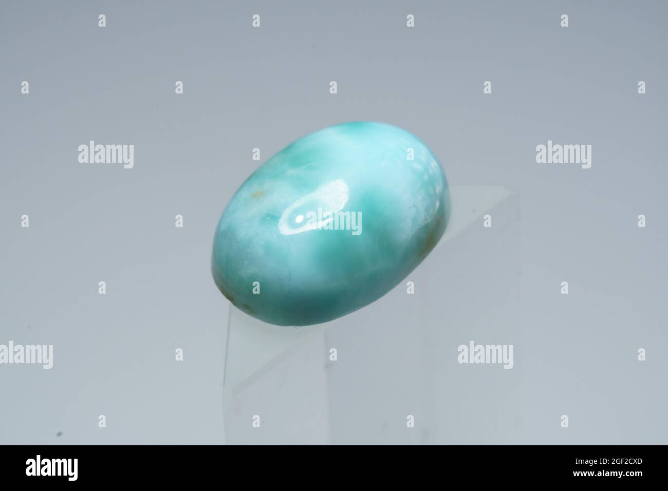 Natural larimar stone on a stand on a white background Stock Photo - Alamy