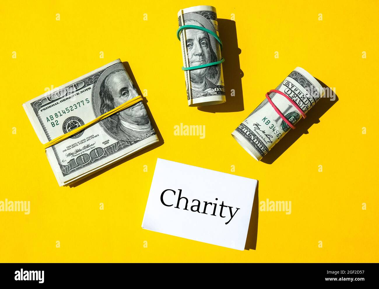 Paper note written word CHARITY in black letters around dollar ...
