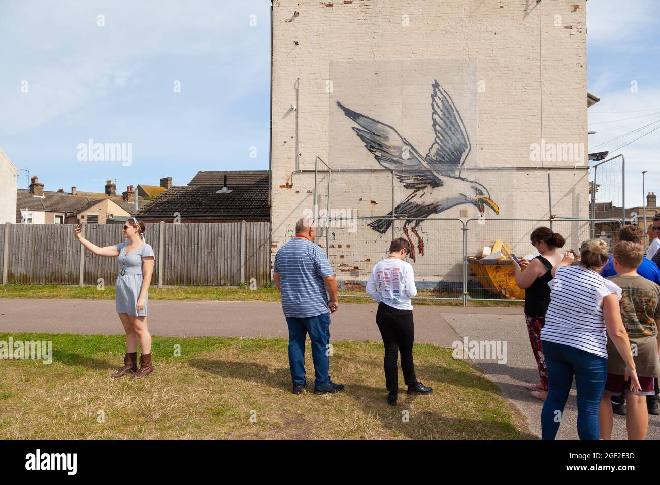 Crowds gathering round Banksy's Seagull street art piece at Lowestoft ...
