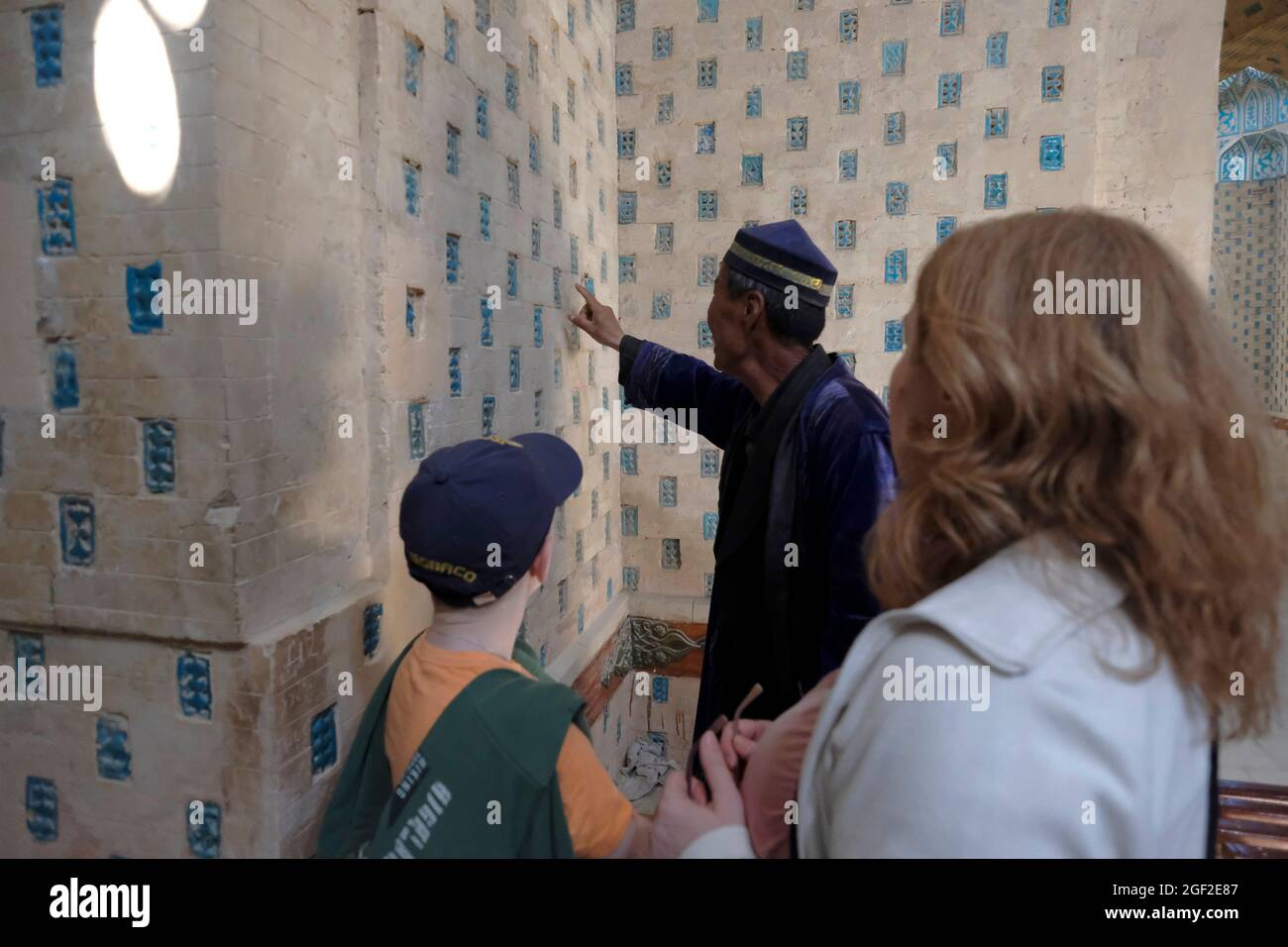 An Uzbek guide gives explanation to Russian tourists inside the ...