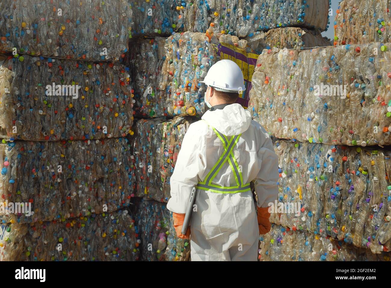 Portrait workers wearing biohazard suits and hardhats working at waste ...