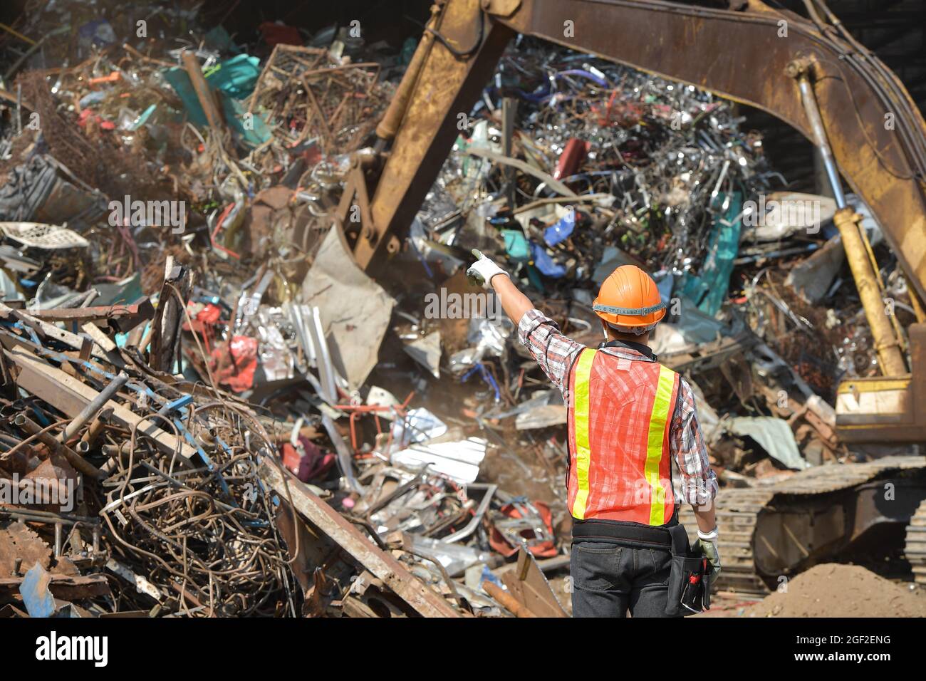 Portrait workers wearing biohazard suits and hardhats working at waste ...