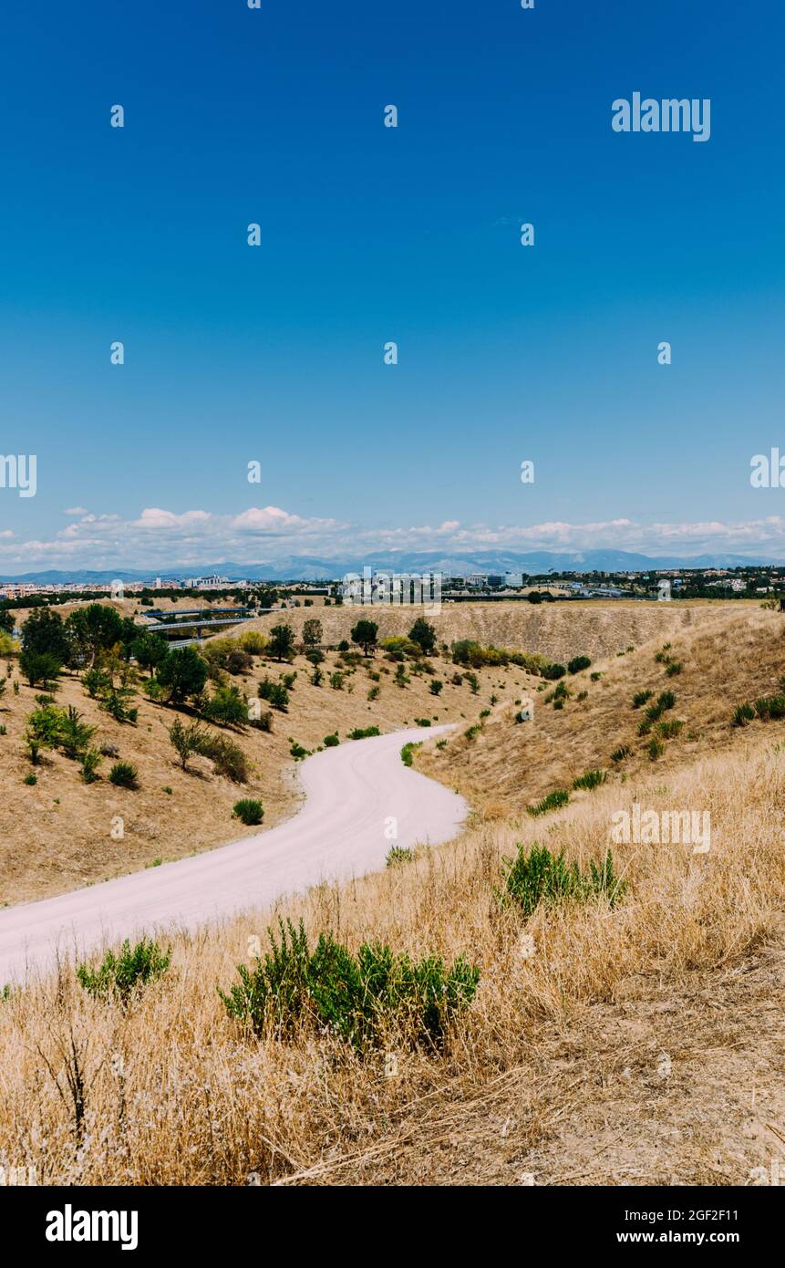 Vertical shot of a pathway surrounded by hills Stock Photo - Alamy