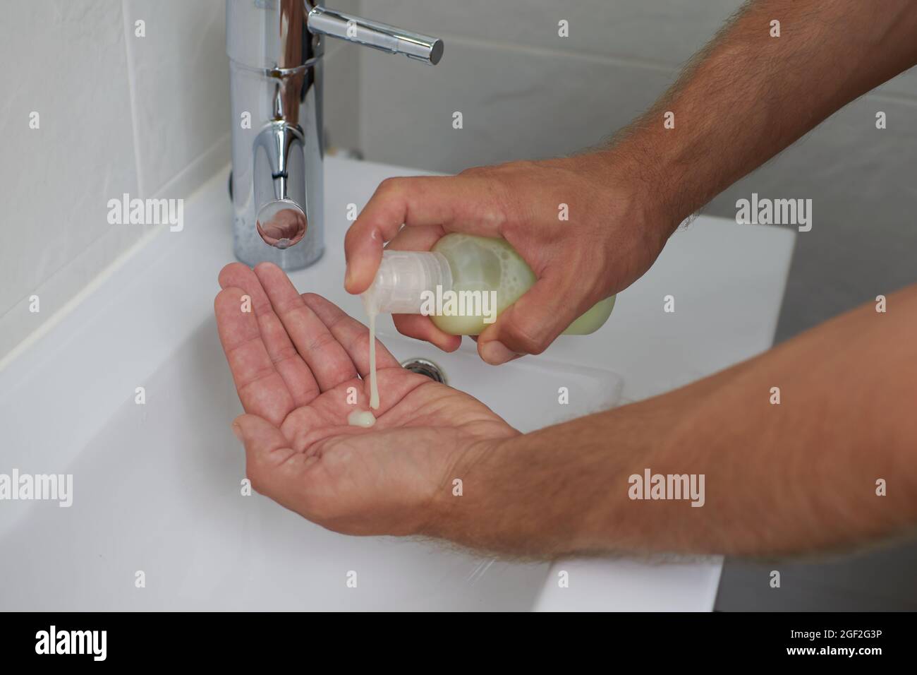 Hand washing with soap in a bathroom Stock Photo - Alamy